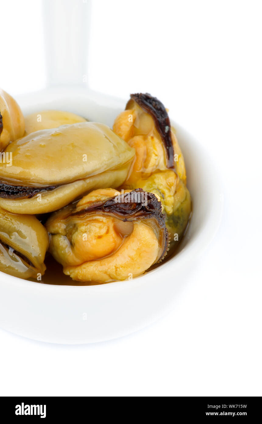 Delicious Smoked Mussels with Olive Oil in White Bowl closeup on white ...