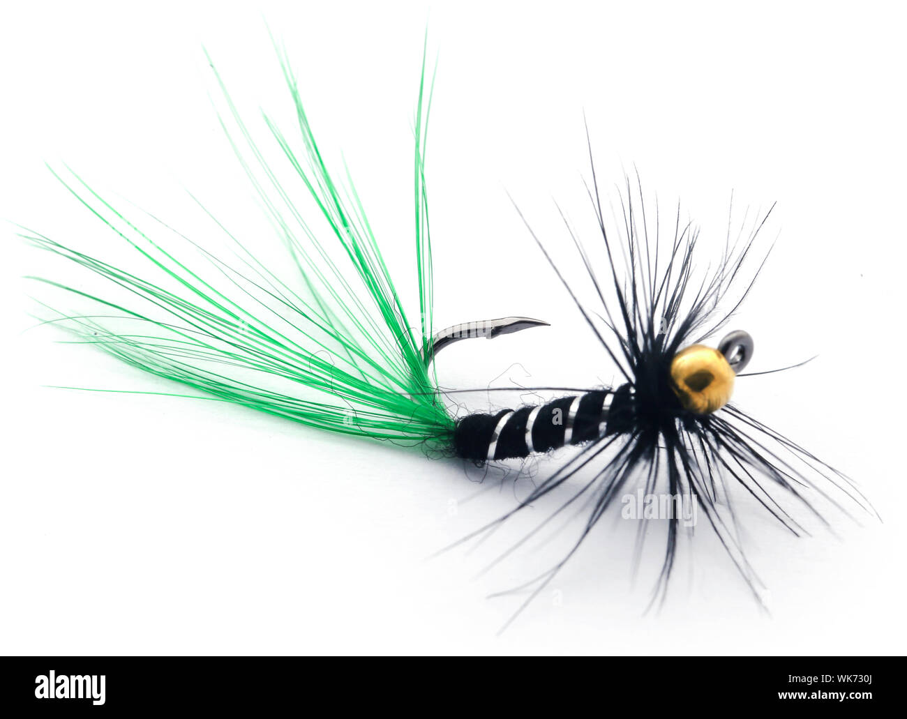 Fishing fly with hook over white background Stock Photo - Alamy