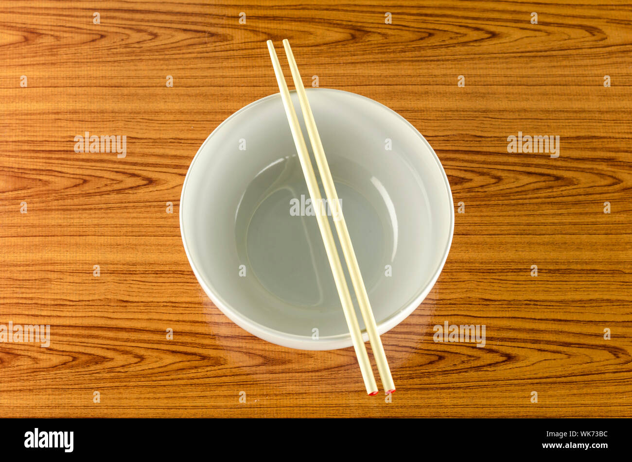 empty white bowl with chopstick on wood table background Stock Photo ...