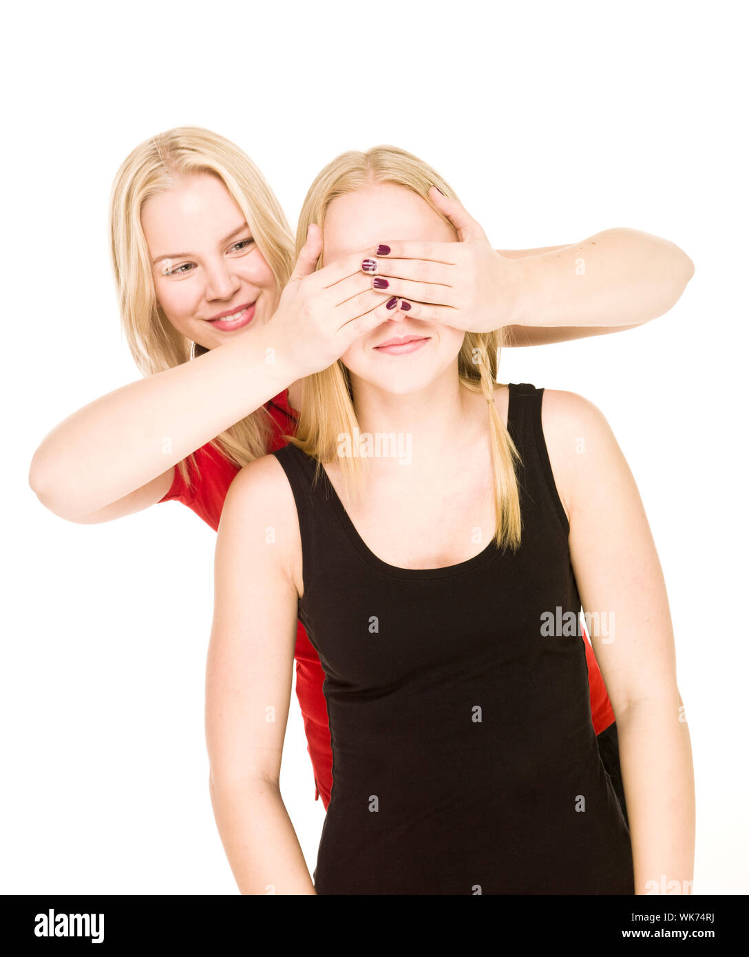 Girls playing Peek-a-boo isolated on white background Stock Photo - Alamy