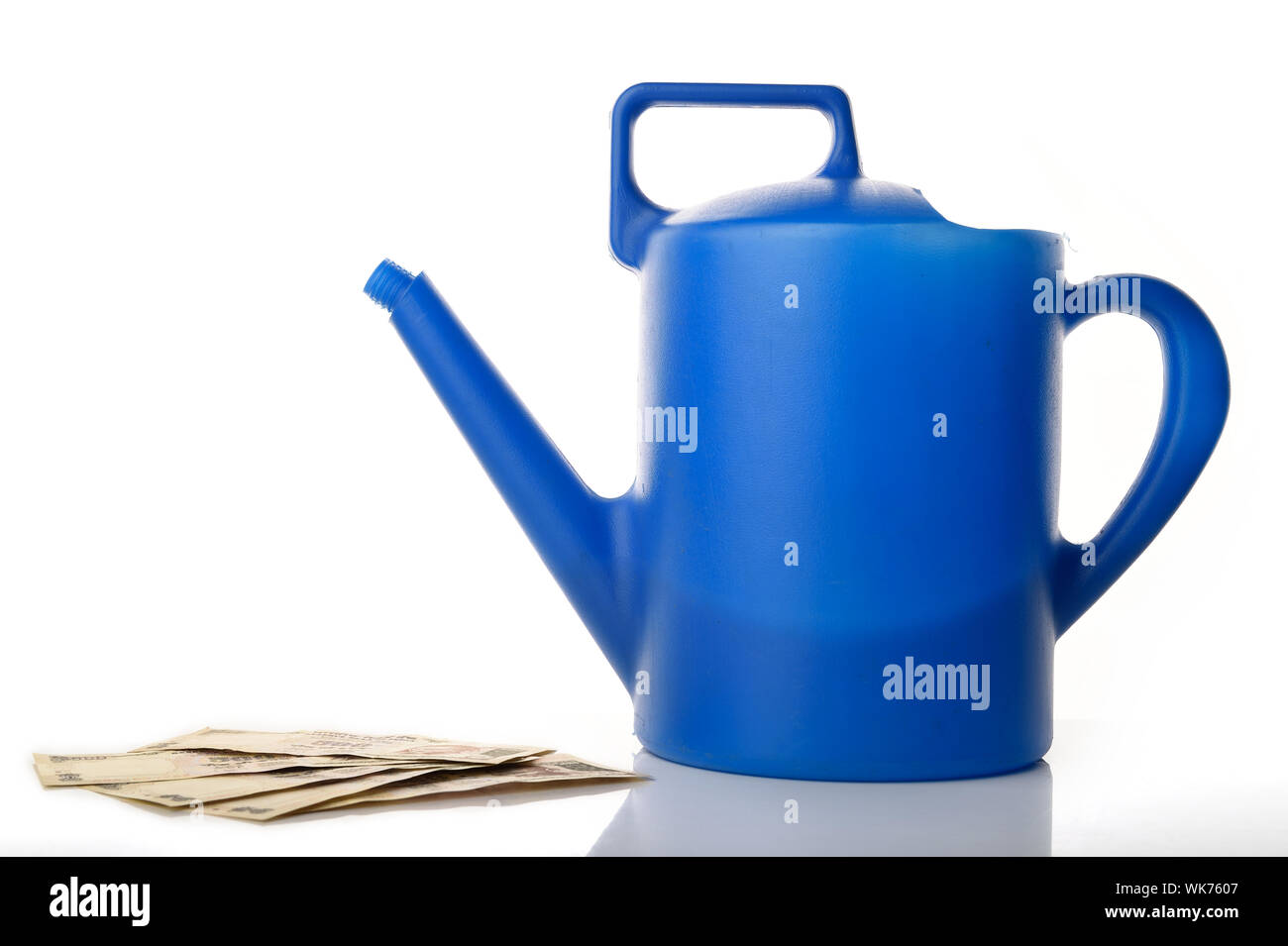 Paper money with watering can as concepts of investment Stock Photo - Alamy