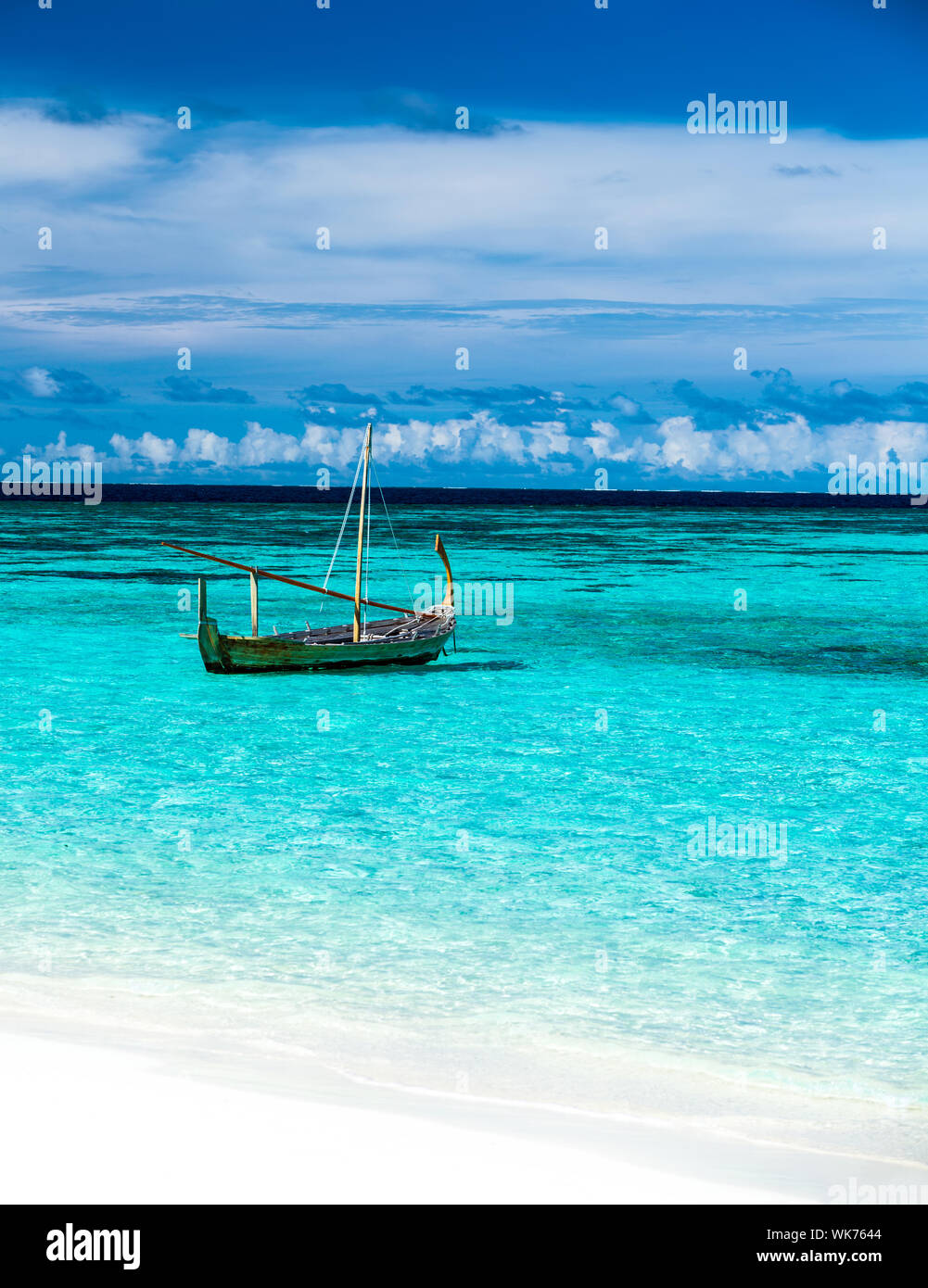 Little fishing boat in blue sea, clear transparent water and white ...