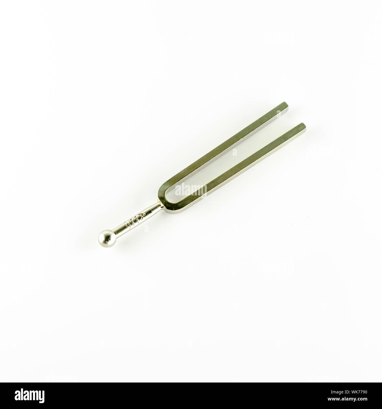 music tools tuning fork on a white background Stock Photo - Alamy