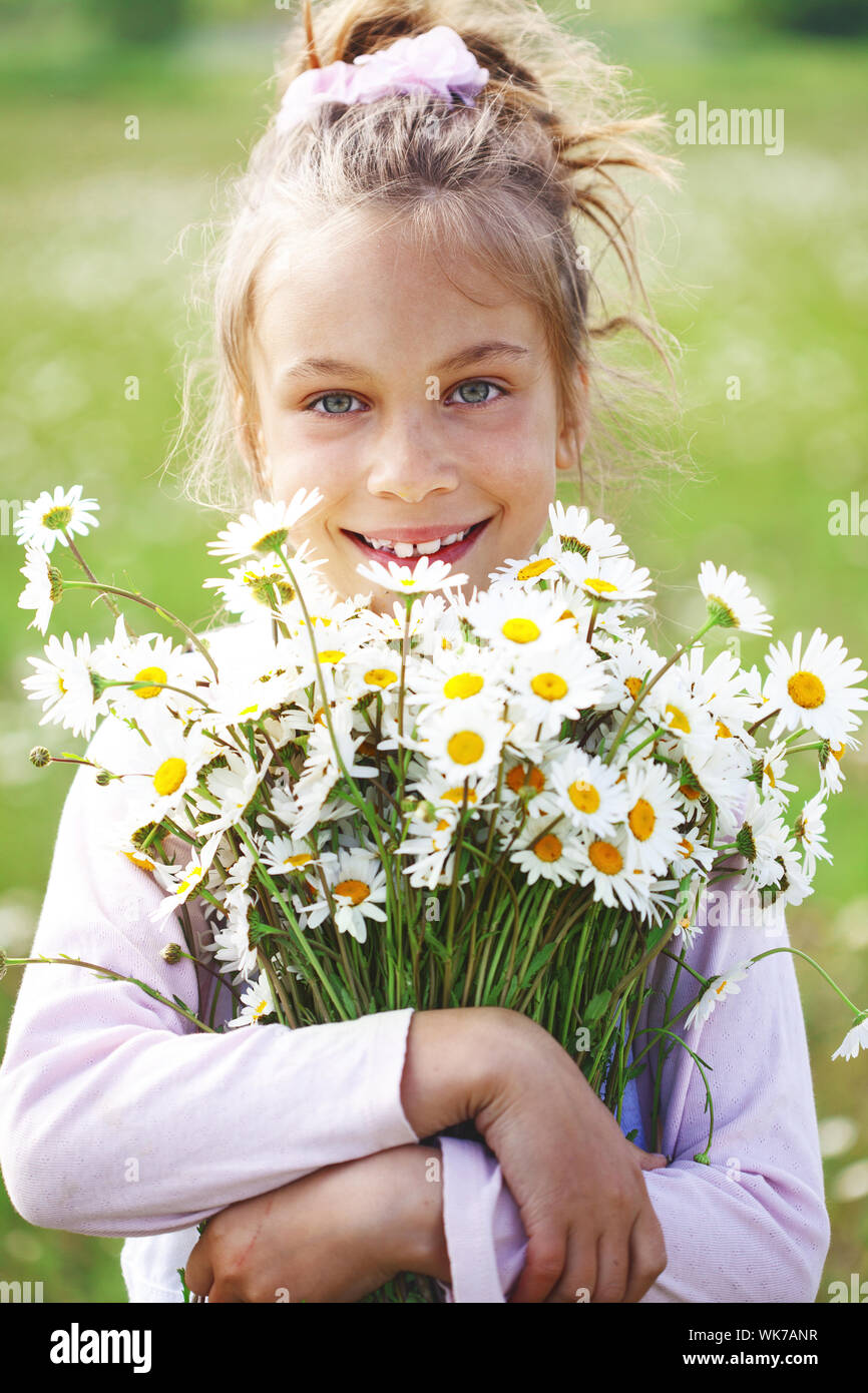 7 years old child having fun in flower field Stock Photo - Alamy