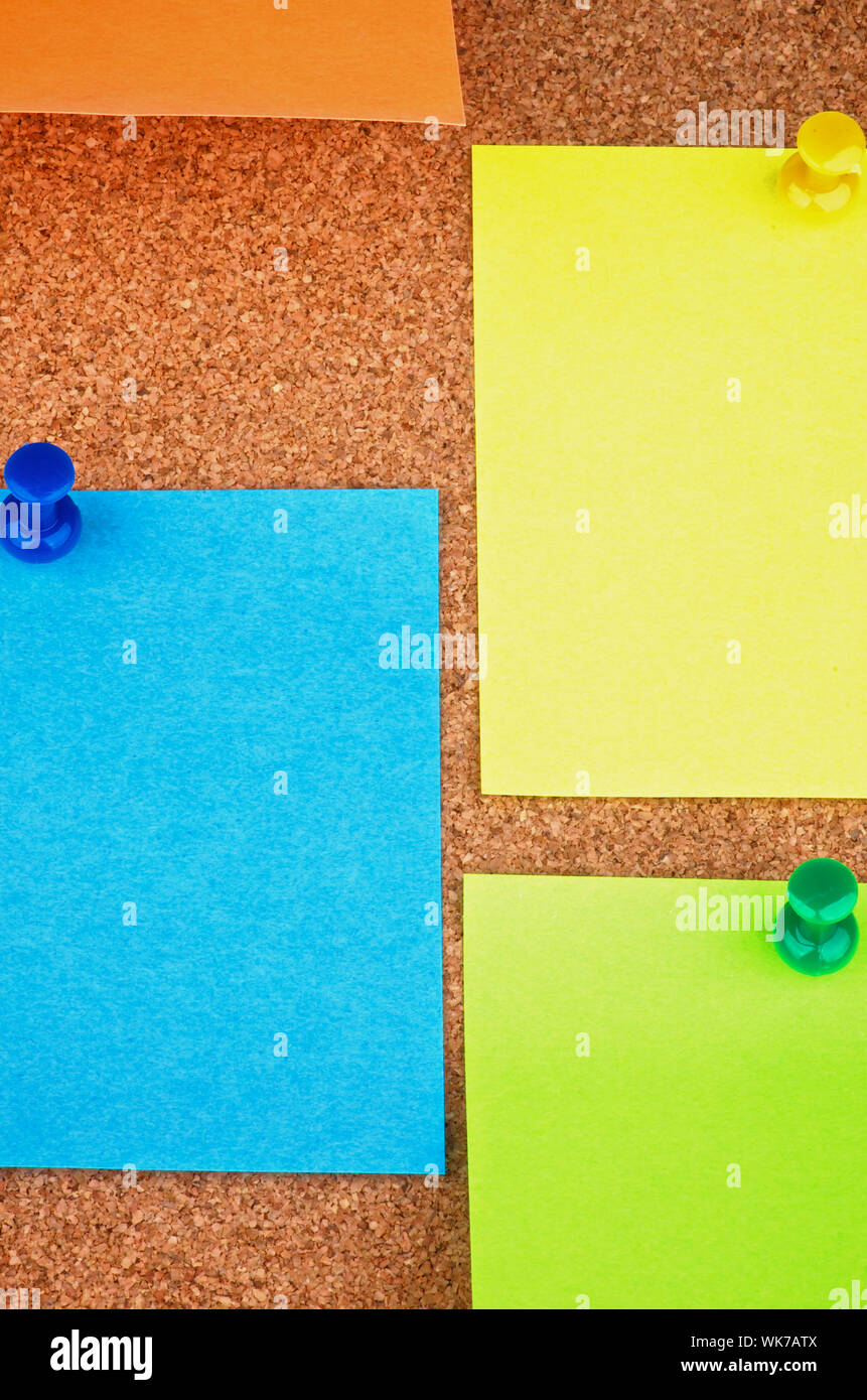 Colorful Sticky Notes with Thumb Tacks closeup on Corkboard Stock Photo ...