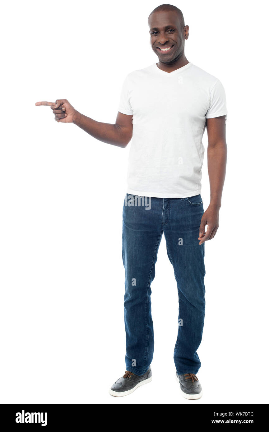 Handsome casual man pointing away Stock Photo - Alamy