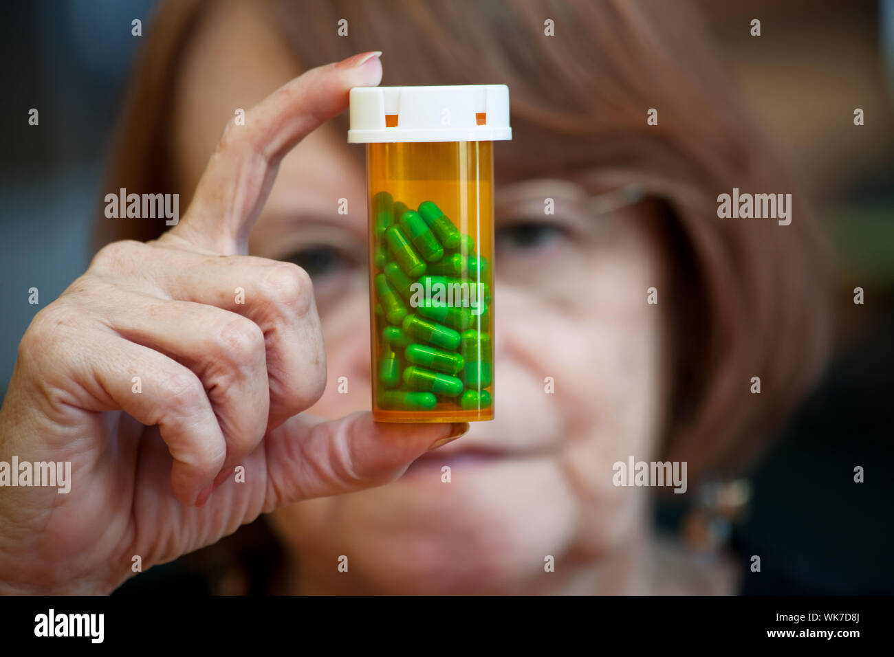 Confused woman reading instructions on prescription pill bottle Stock ...