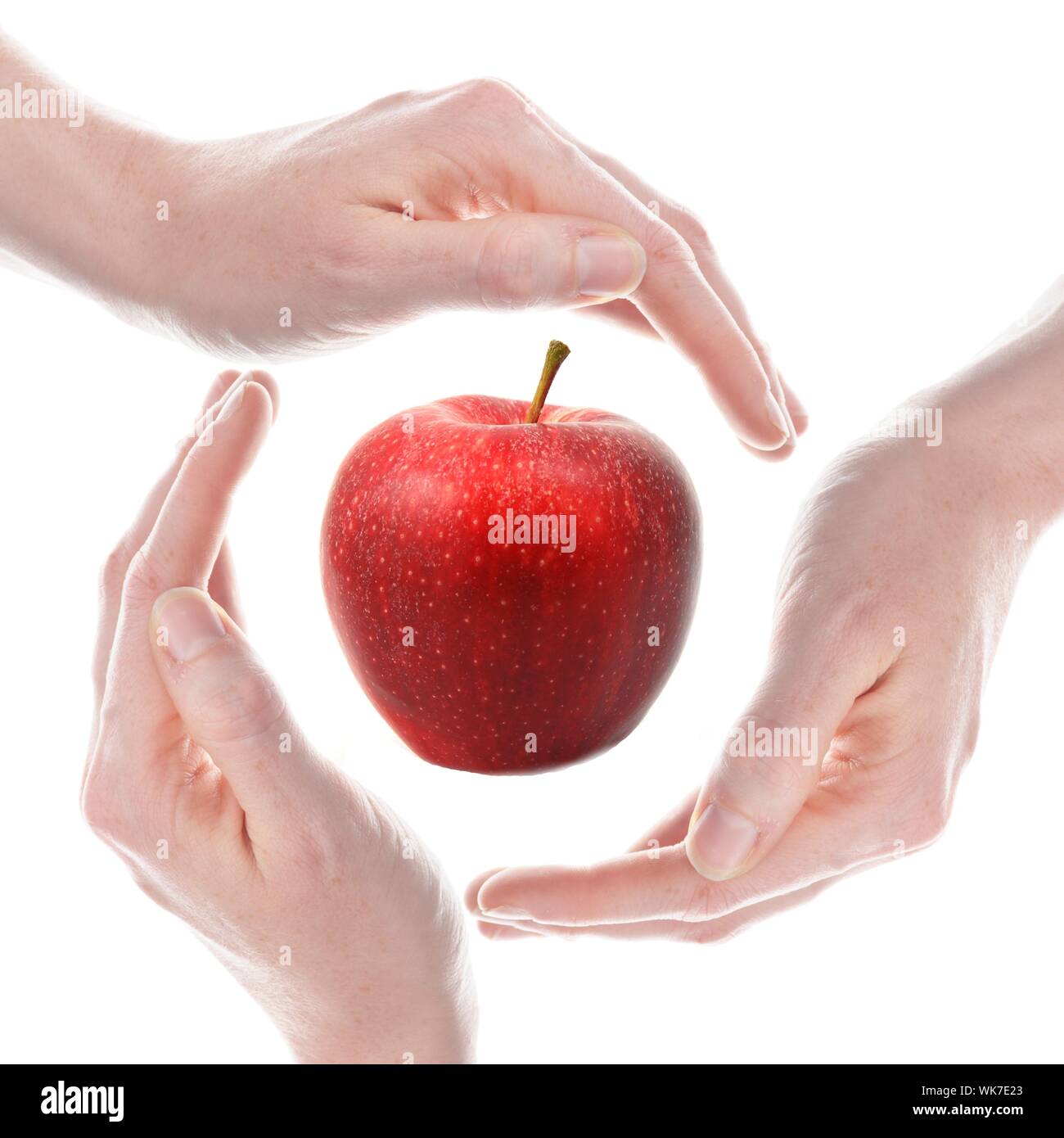 hand and apple isolated on a white background showing healthy food ...