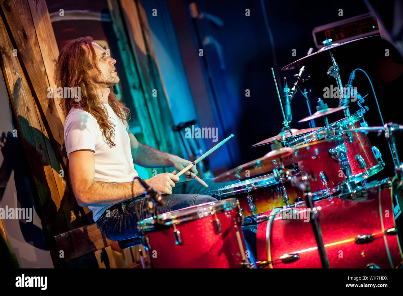 Musician playing drums on stage, rock music concert Stock Photo - Alamy
