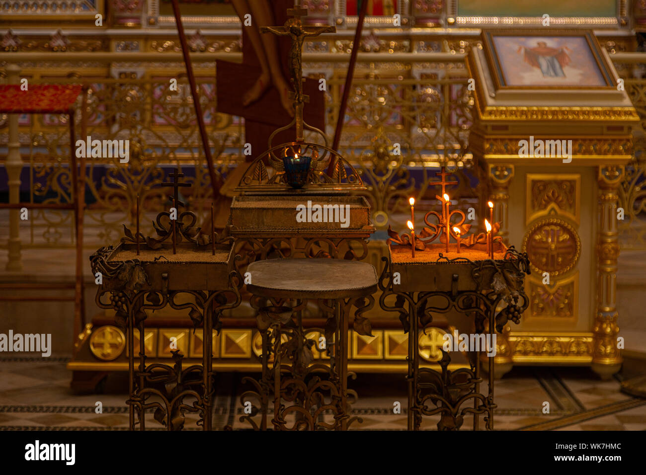 Gradin with burning candles for repose of soul in christian church ...