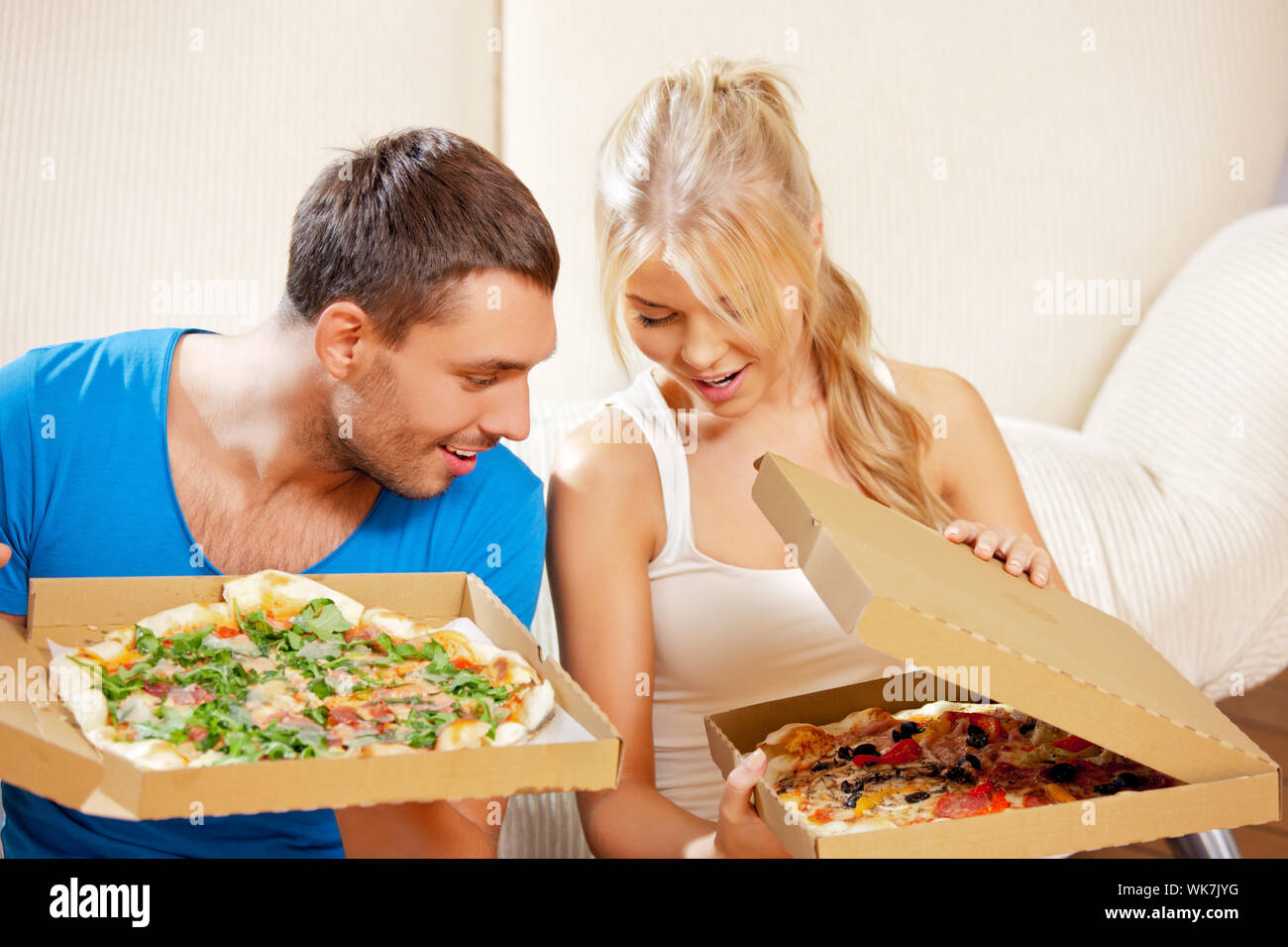 romantic couple eating pizza at home Stock Photo - Alamy