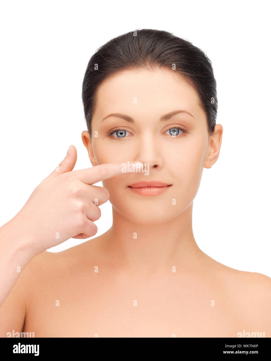 beautiful woman pointing to nose Stock Photo - Alamy