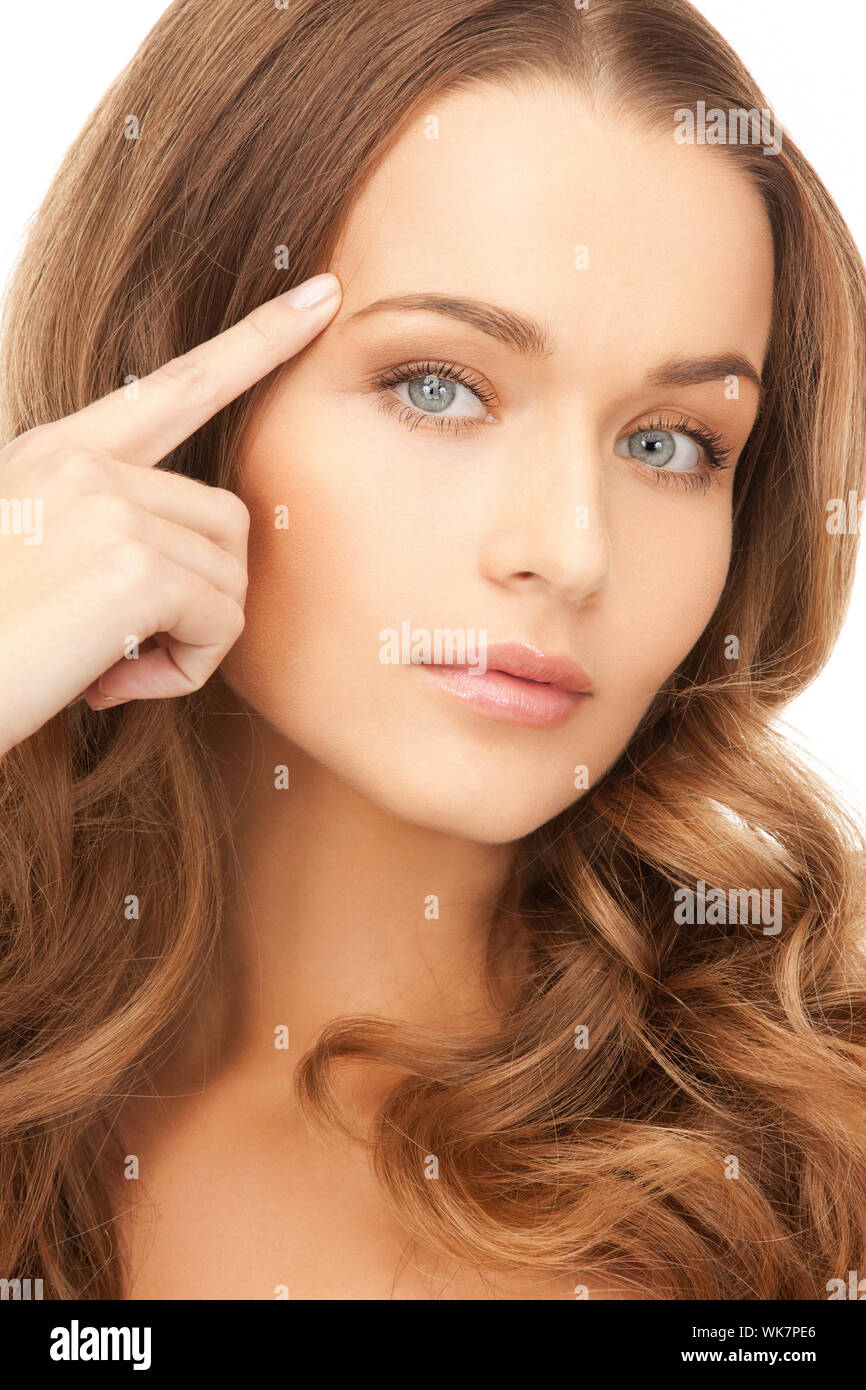 beautiful woman pointing to forehead Stock Photo - Alamy