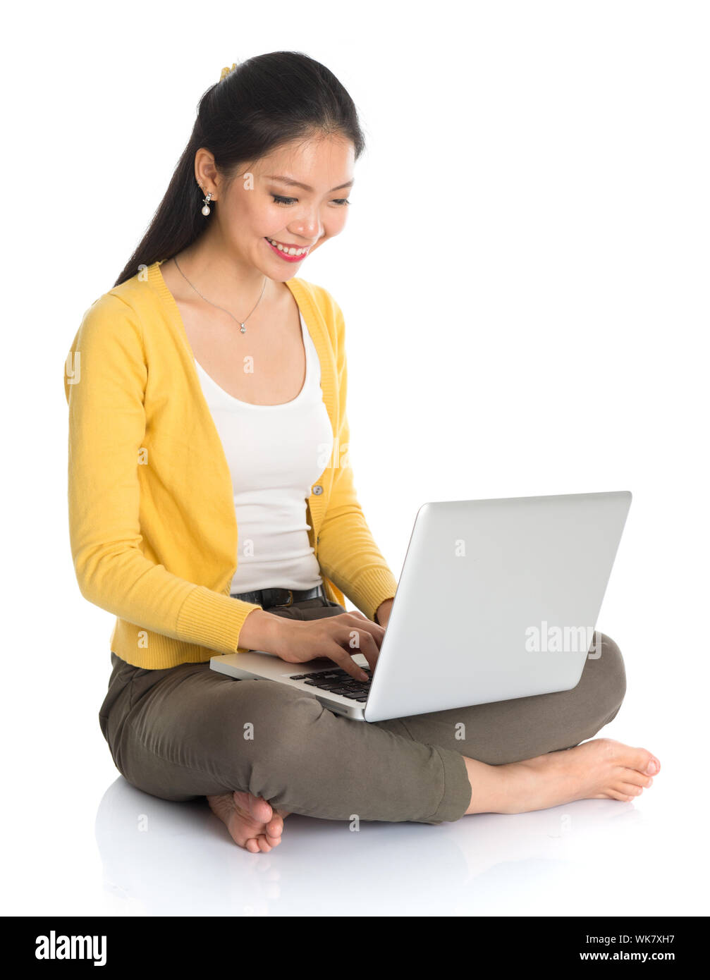 Full body Asian woman in yellow blouse using laptop computer notebook ...