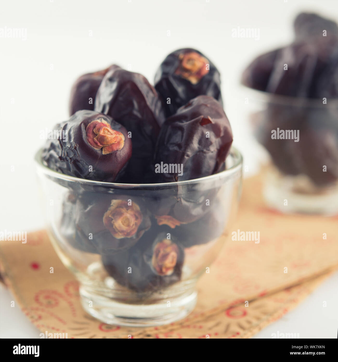 Dates fruit. Pile of dried date fruits in glass on plain background ...