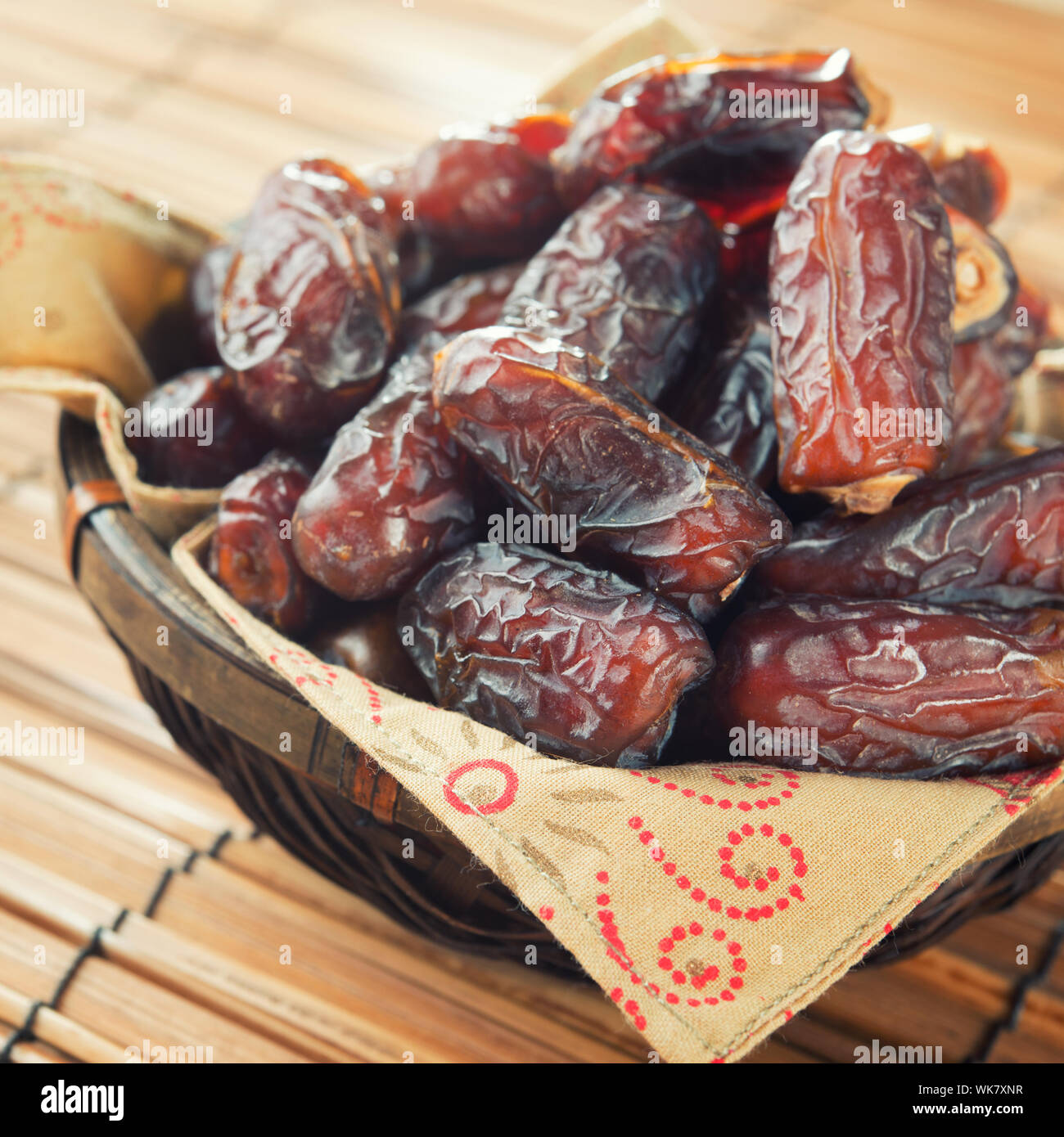 Pile of fresh dried date fruits in bamboo basket. Dried date palm ...