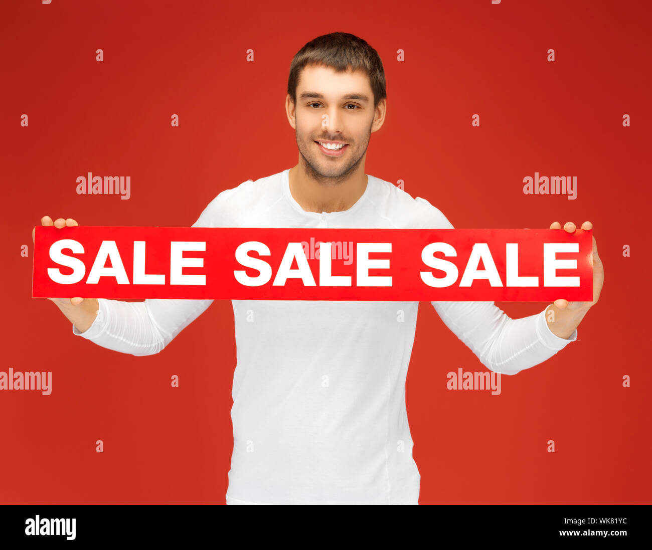 bright picture of handsome man with sale sign Stock Photo - Alamy