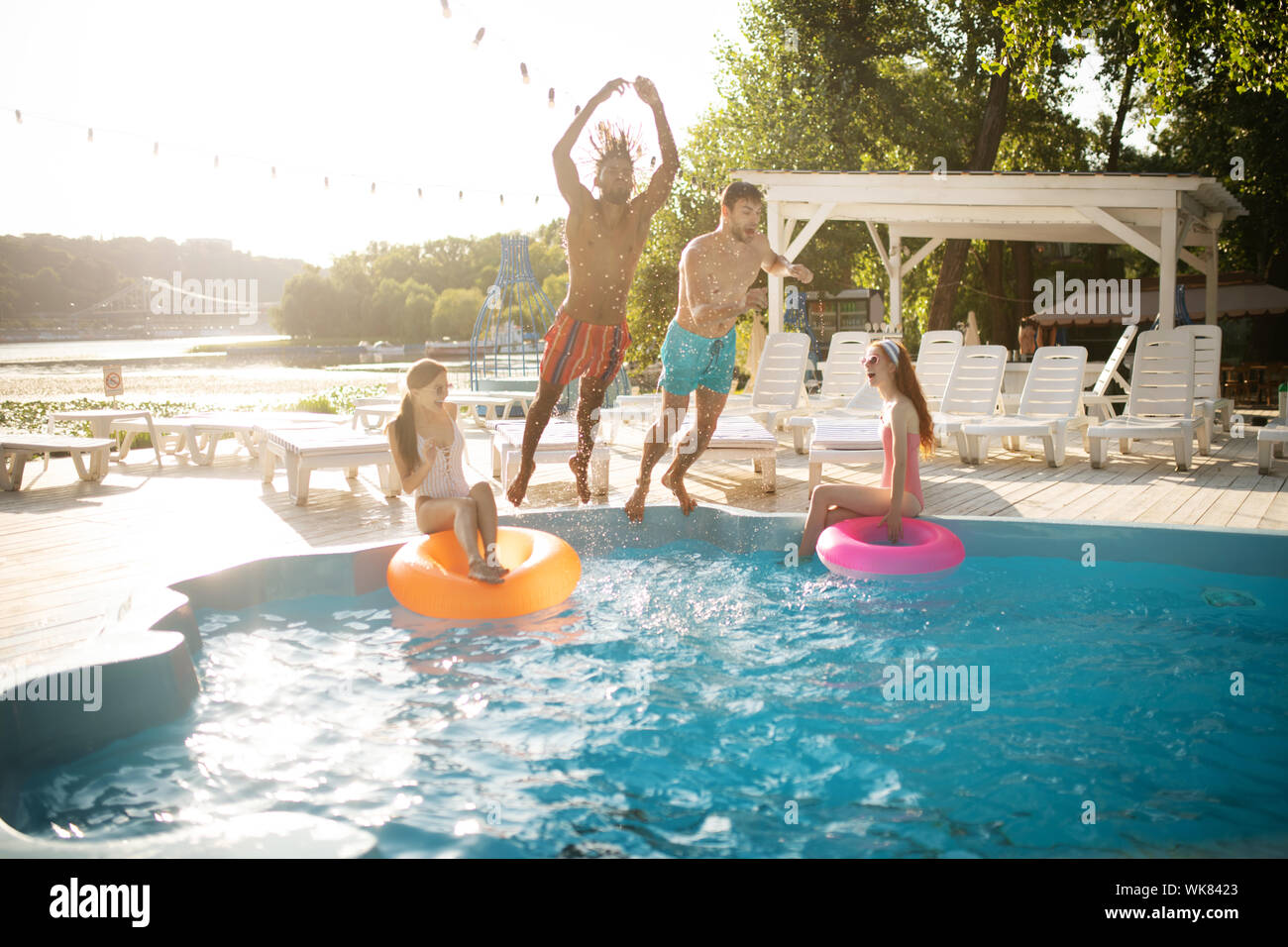 Woman jumping into pool hi-res stock photography and images - Alamy