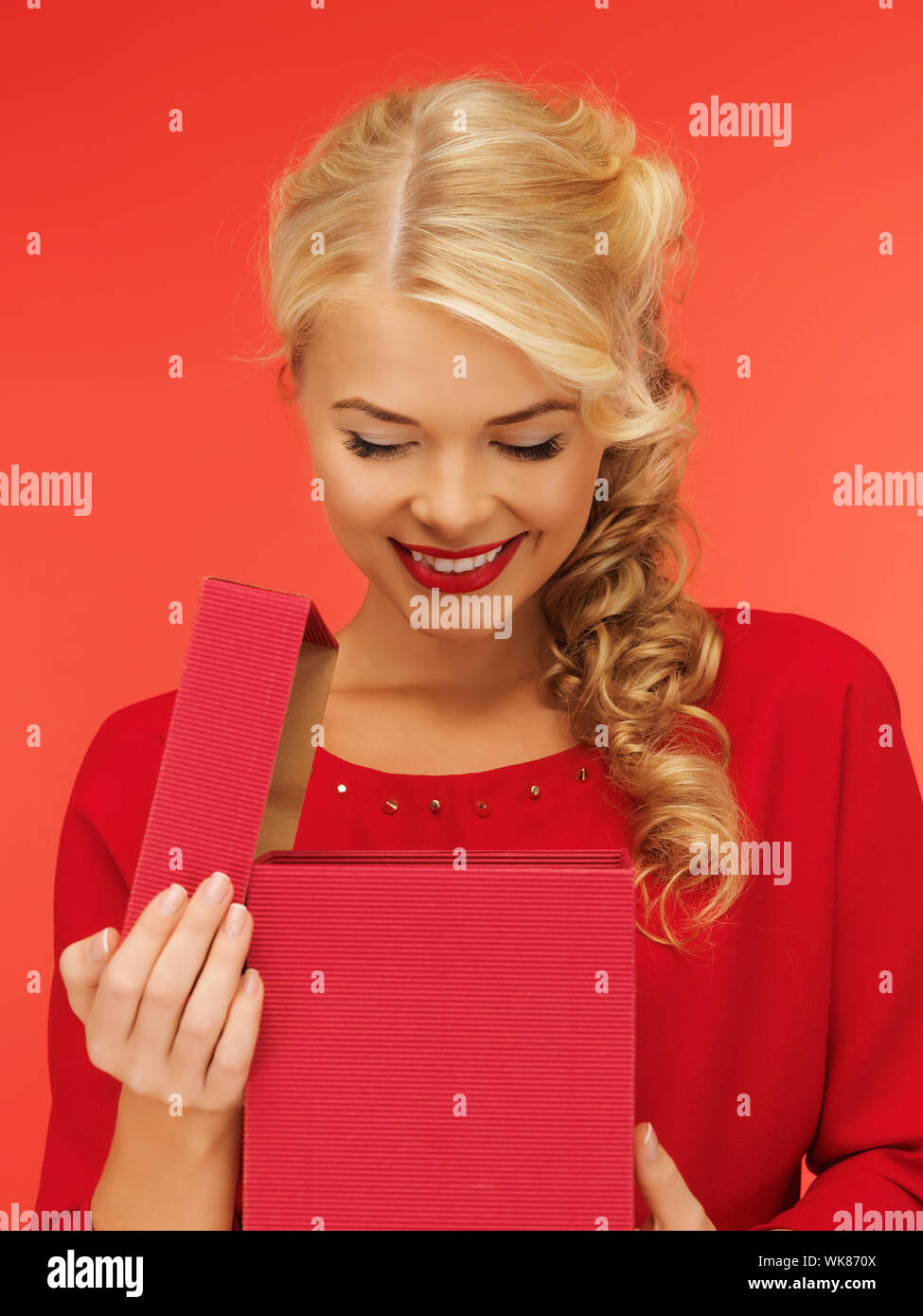 lovely woman in red dress with opened gift box Stock Photo - Alamy