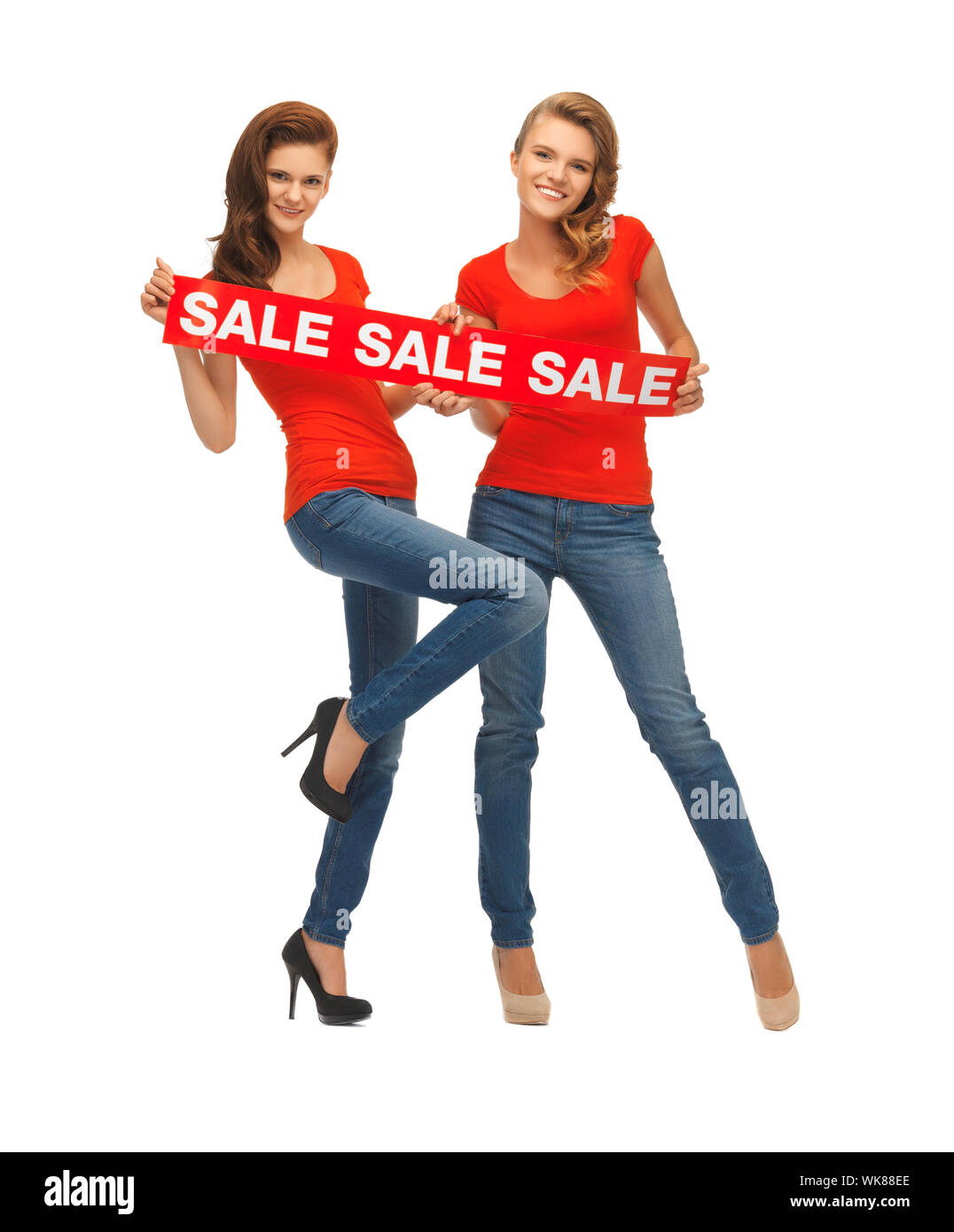 two teenage girls with sale sign Stock Photo - Alamy