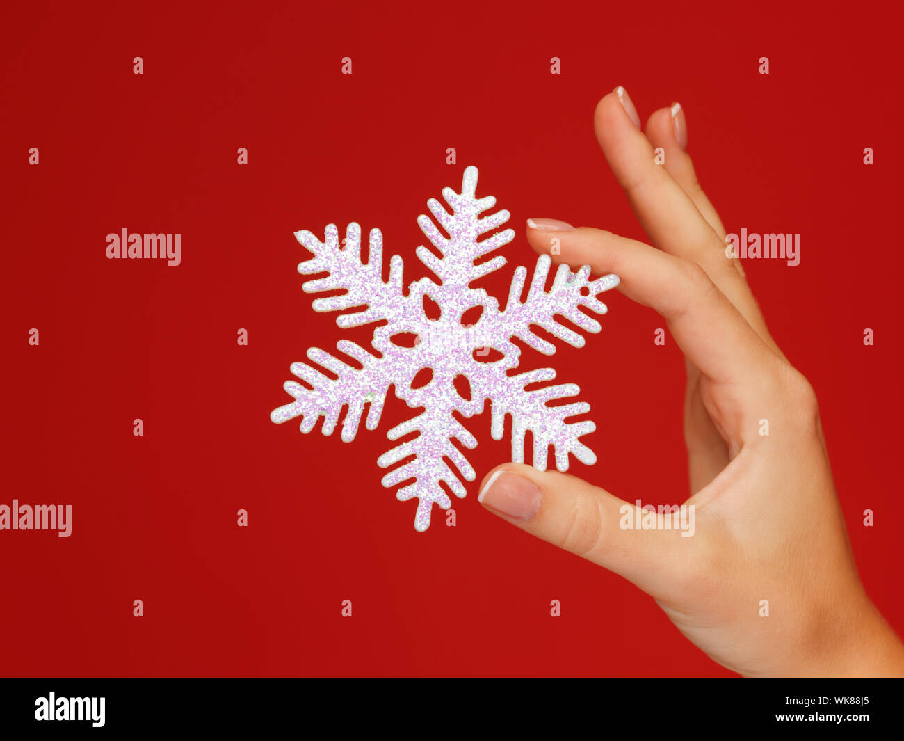 woman's hands holding a snowflake Stock Photo - Alamy