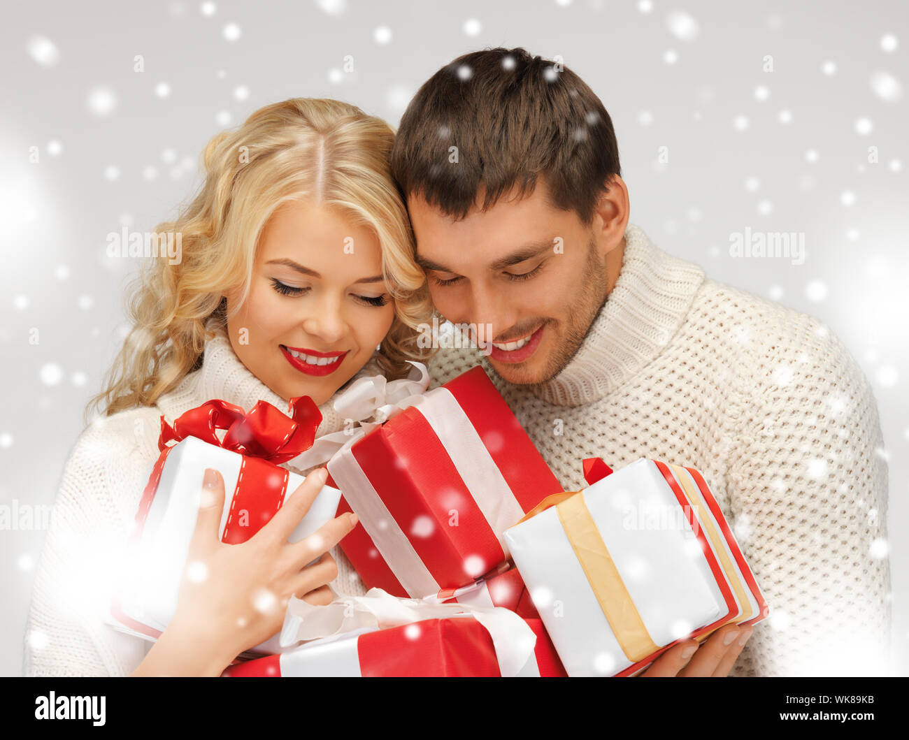 picture of romantic couple in a sweaters with gift boxes Stock Photo ...
