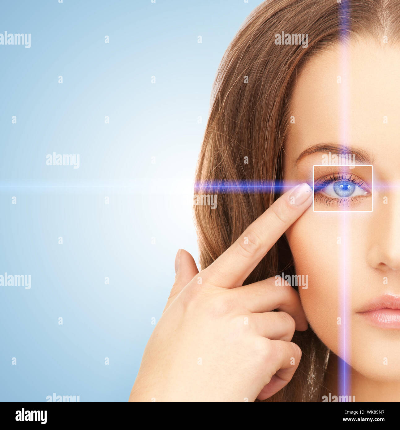 beautiful woman pointing to eye Stock Photo - Alamy