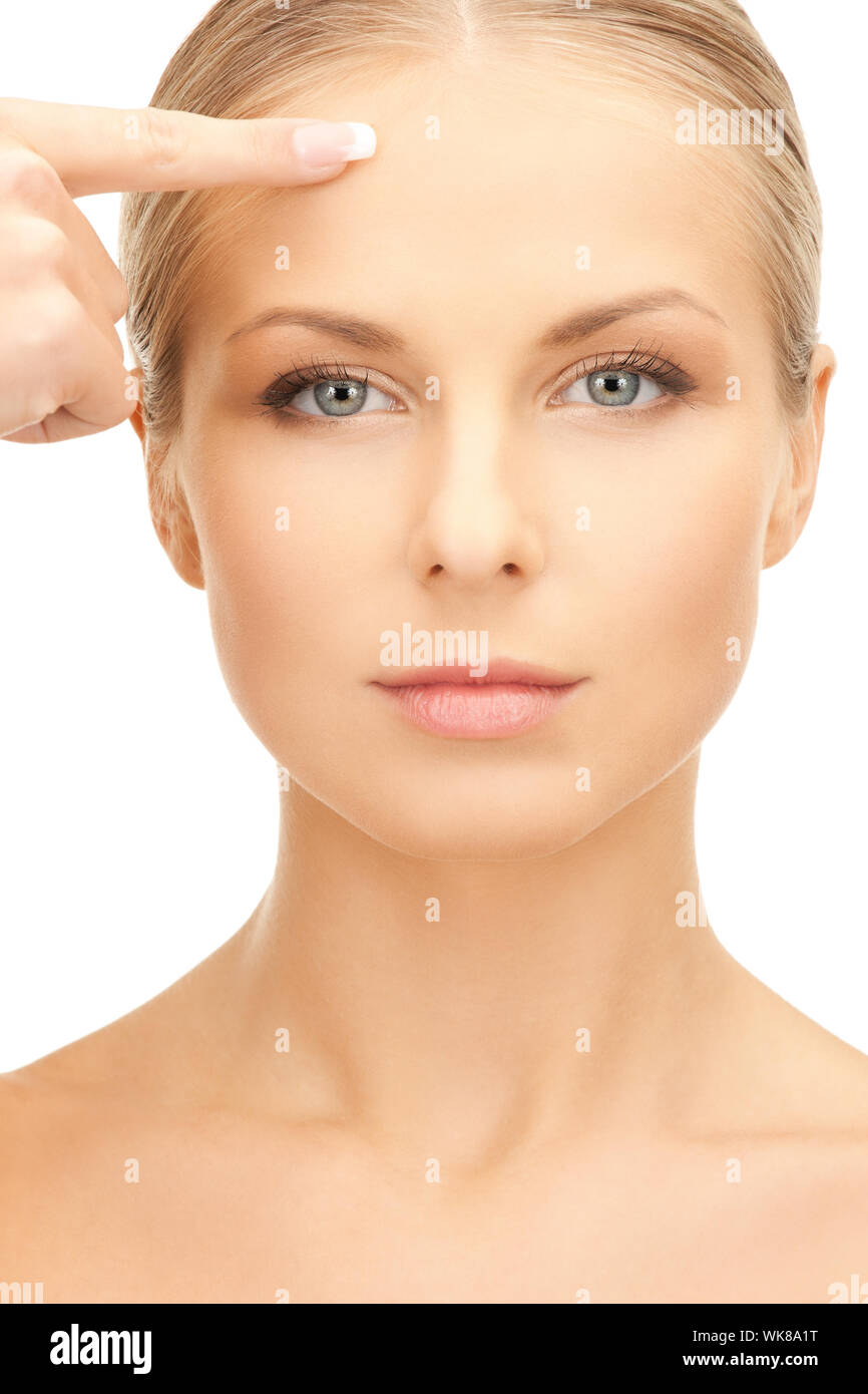 beautiful woman pointing to forehead Stock Photo - Alamy