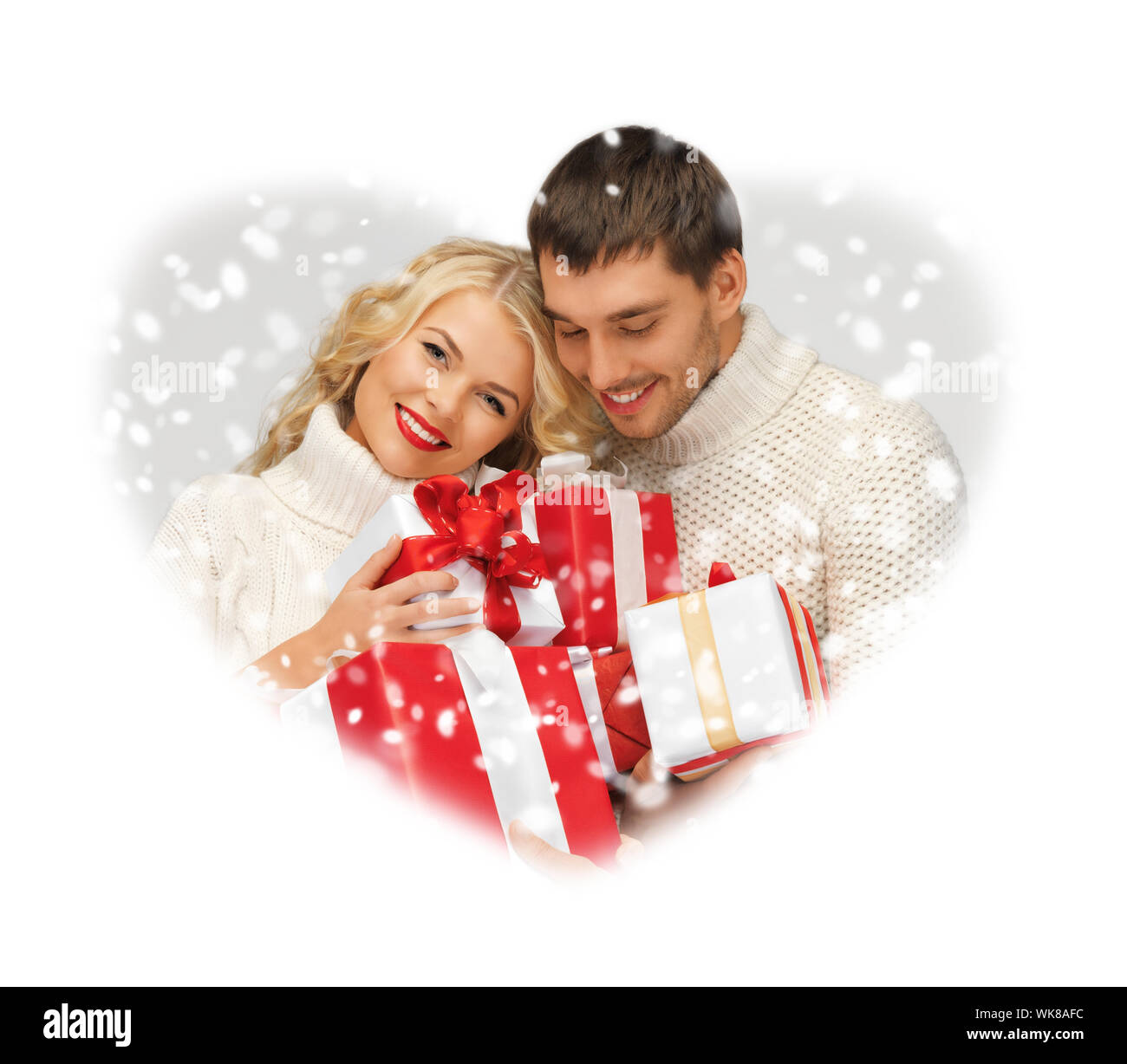 romantic couple in a sweaters with gift boxes Stock Photo - Alamy