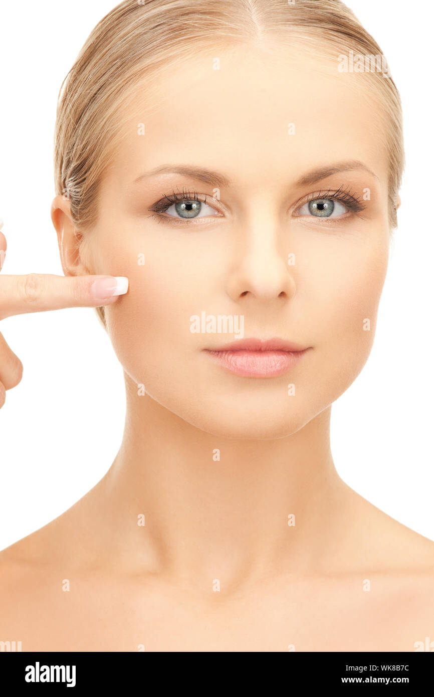 beautiful woman pointing to cheek Stock Photo - Alamy