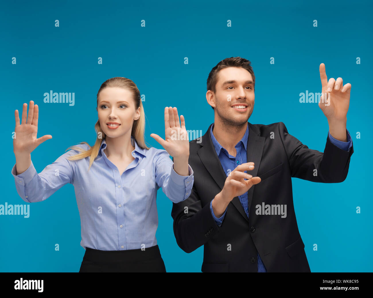 picture of man and woman working with something imaginary Stock Photo ...