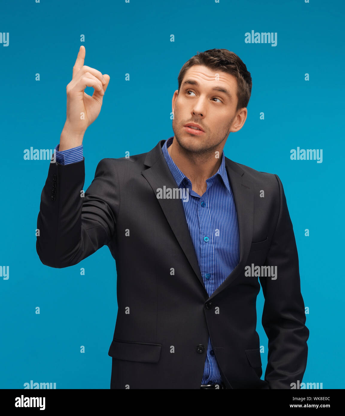 picture of man in suit with his finger up Stock Photo - Alamy
