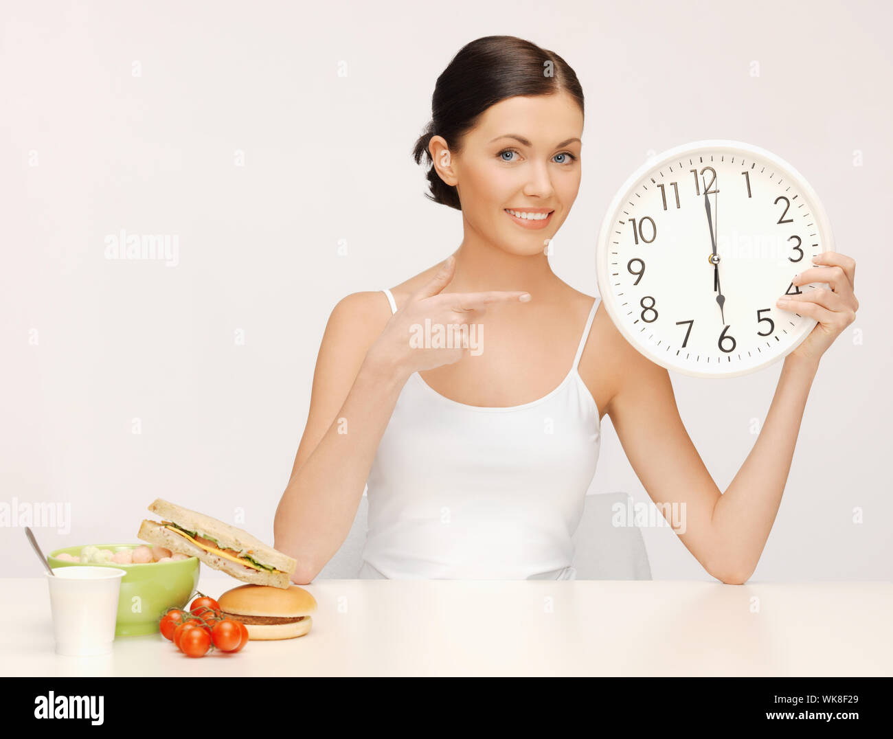 picture of beautiful woman with big clock Stock Photo - Alamy