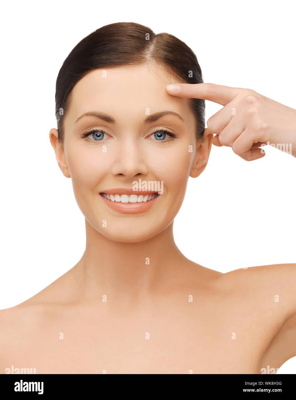 beautiful woman pointing to forehead Stock Photo - Alamy