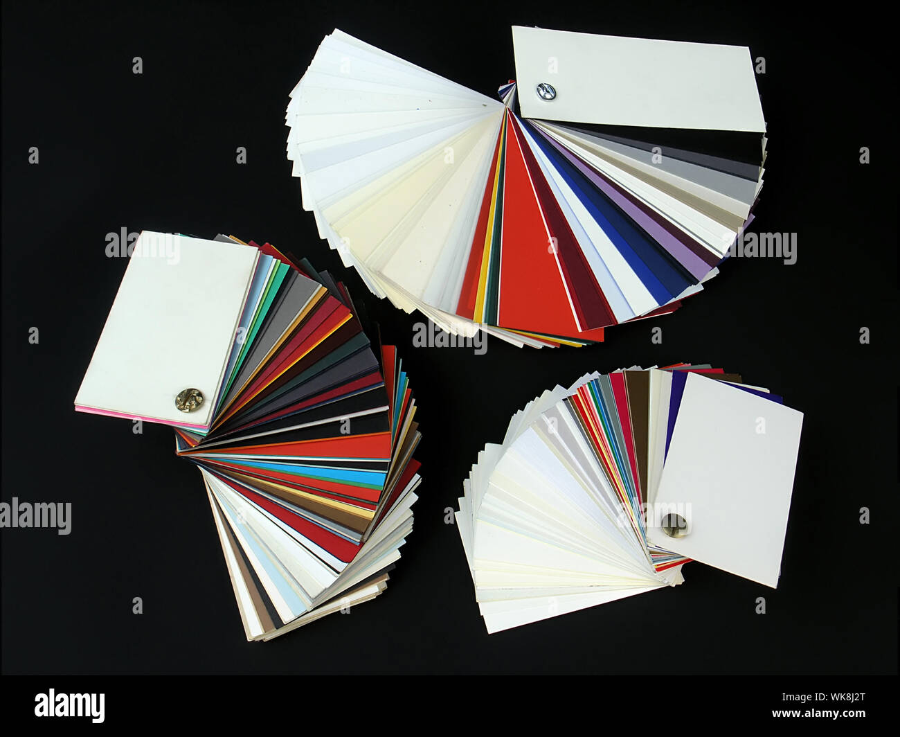 Colored samples of different papers on black background Stock Photo - Alamy