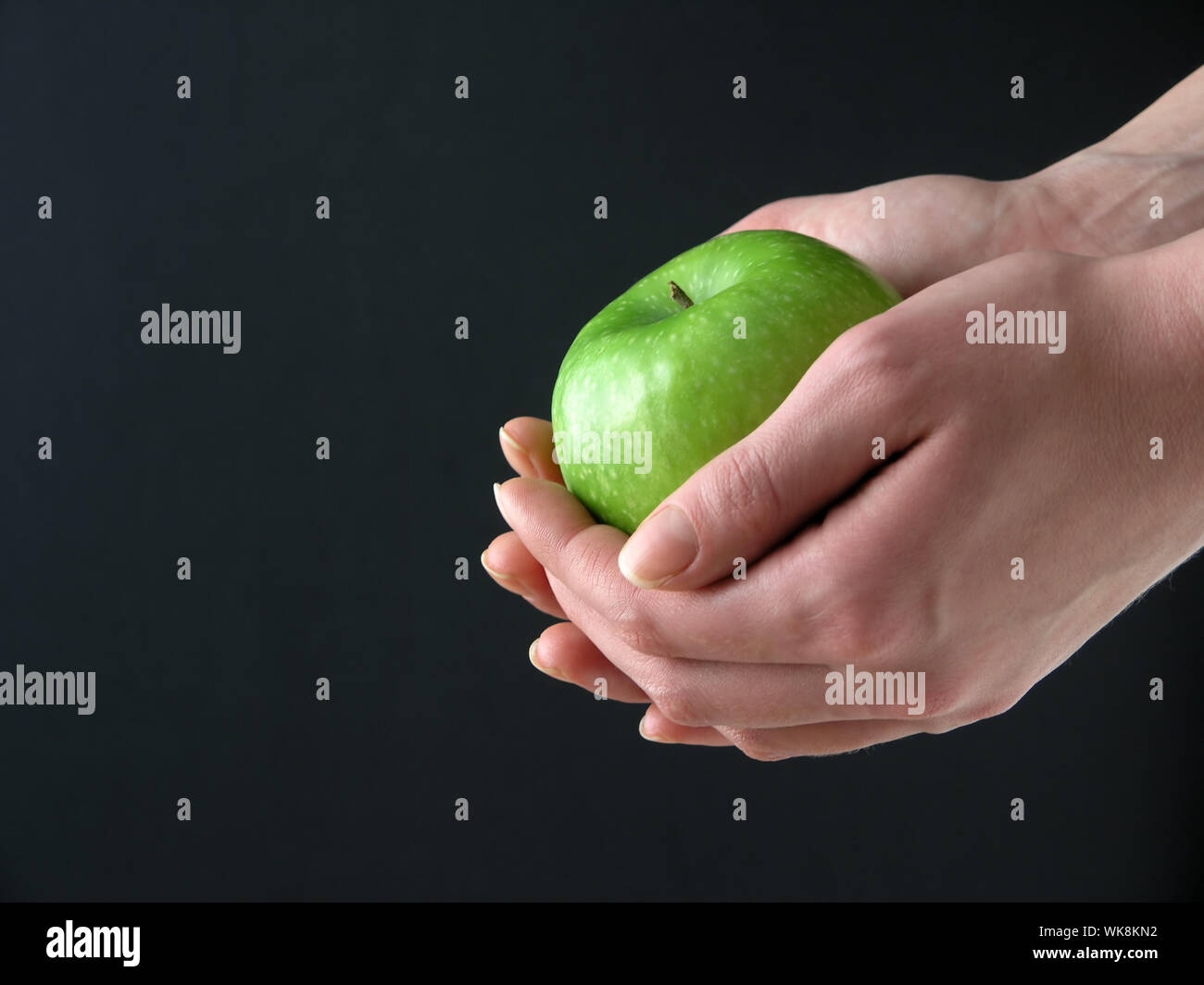 Apple in hands Stock Photo - Alamy