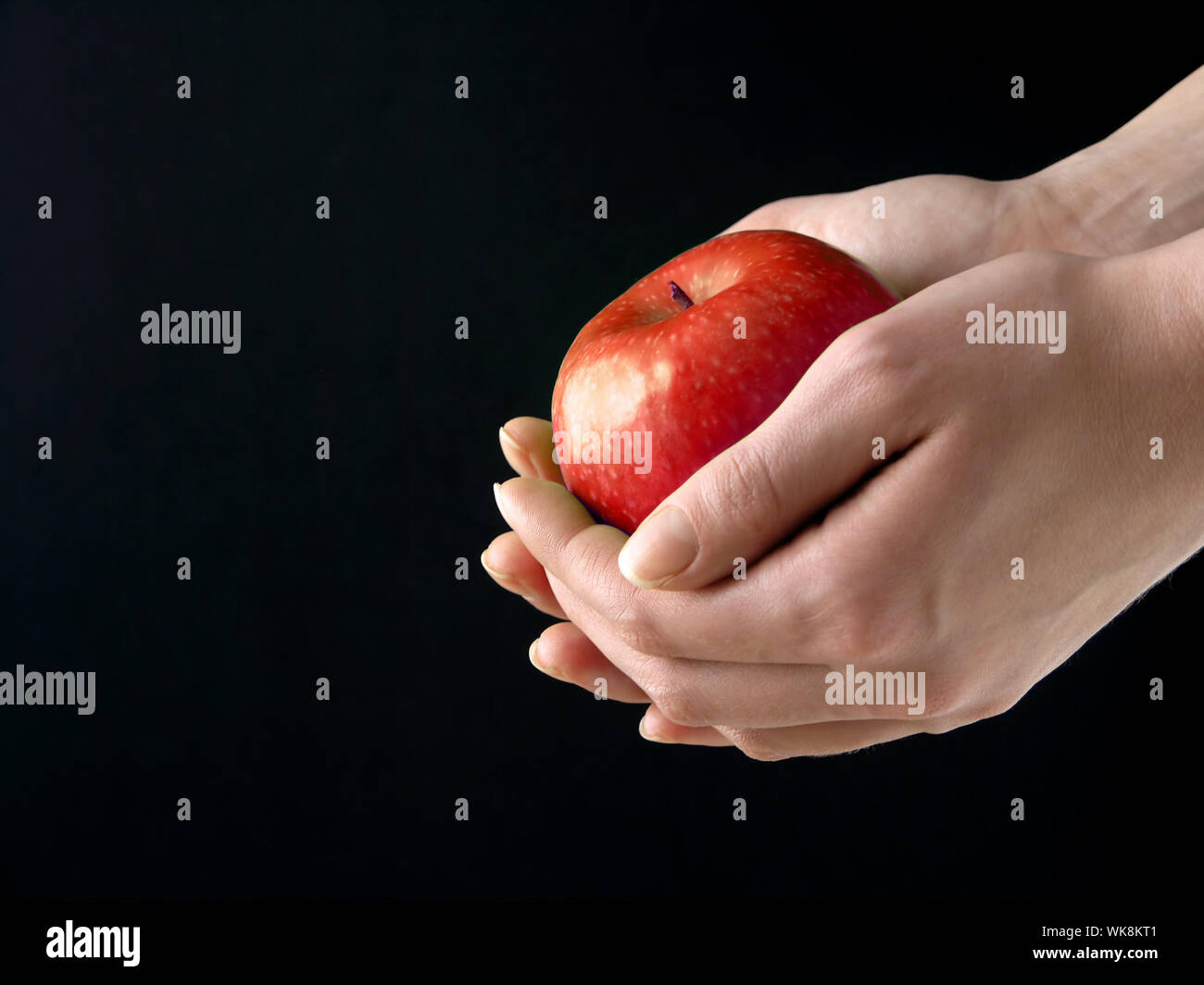Apple in hands Stock Photo - Alamy