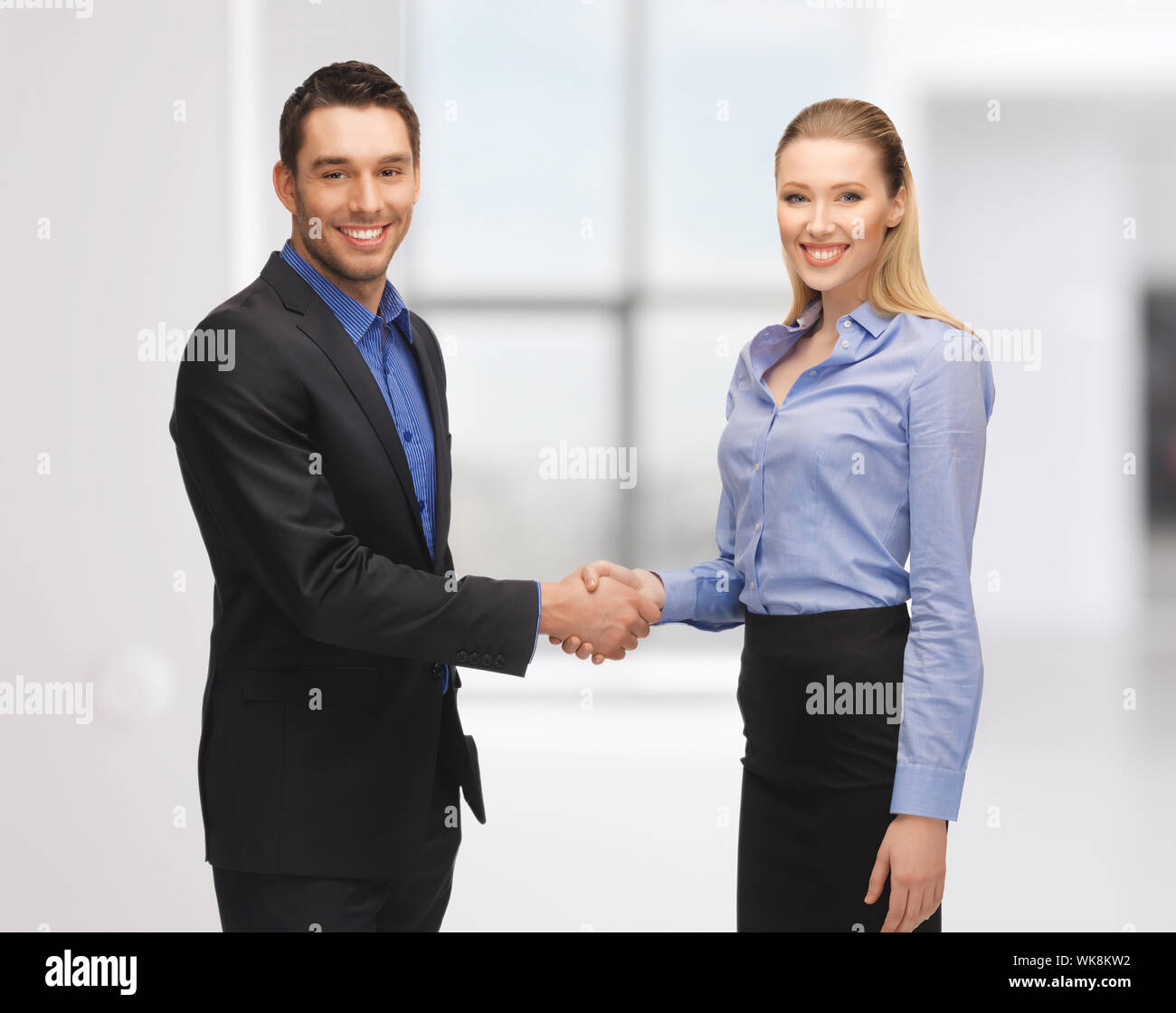 bright picture of man and woman shaking their hands Stock Photo - Alamy