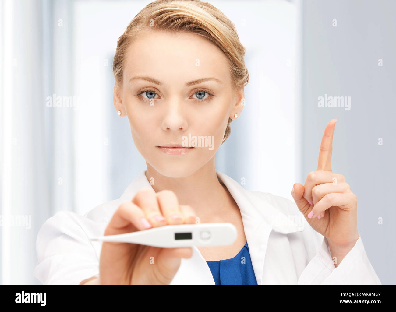 attractive female doctor with thermometer Stock Photo - Alamy