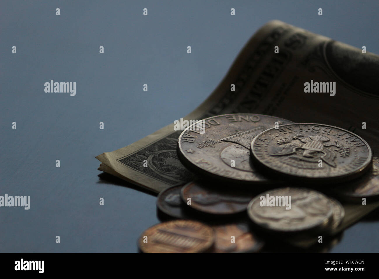 Shabby dollar bills and coins still life Stock Photo - Alamy