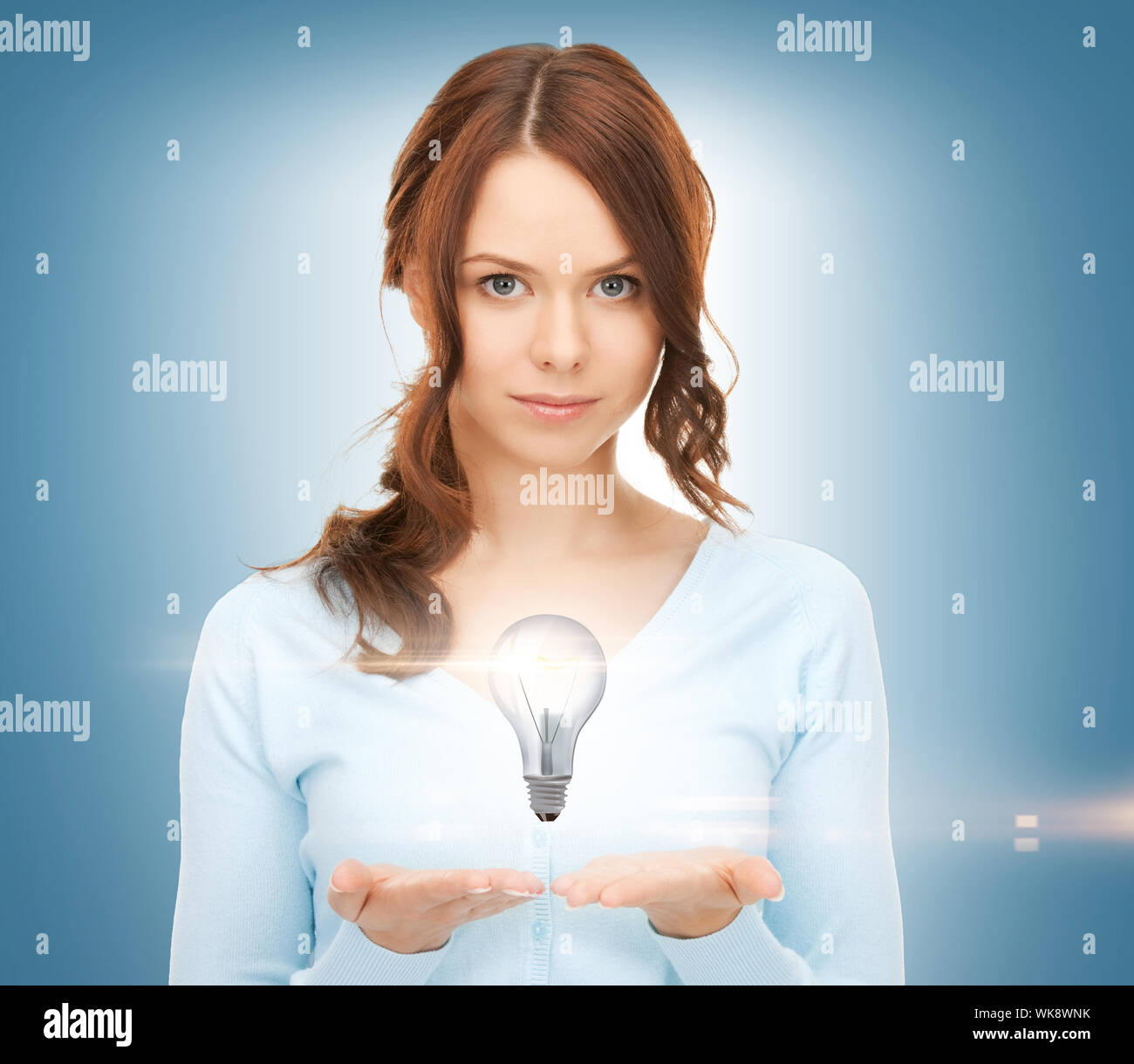 beautiful woman showing light bulb on her hands Stock Photo - Alamy