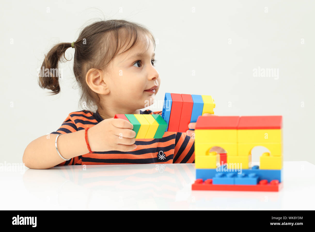 Girl playing with building blocks Stock Photo - Alamy