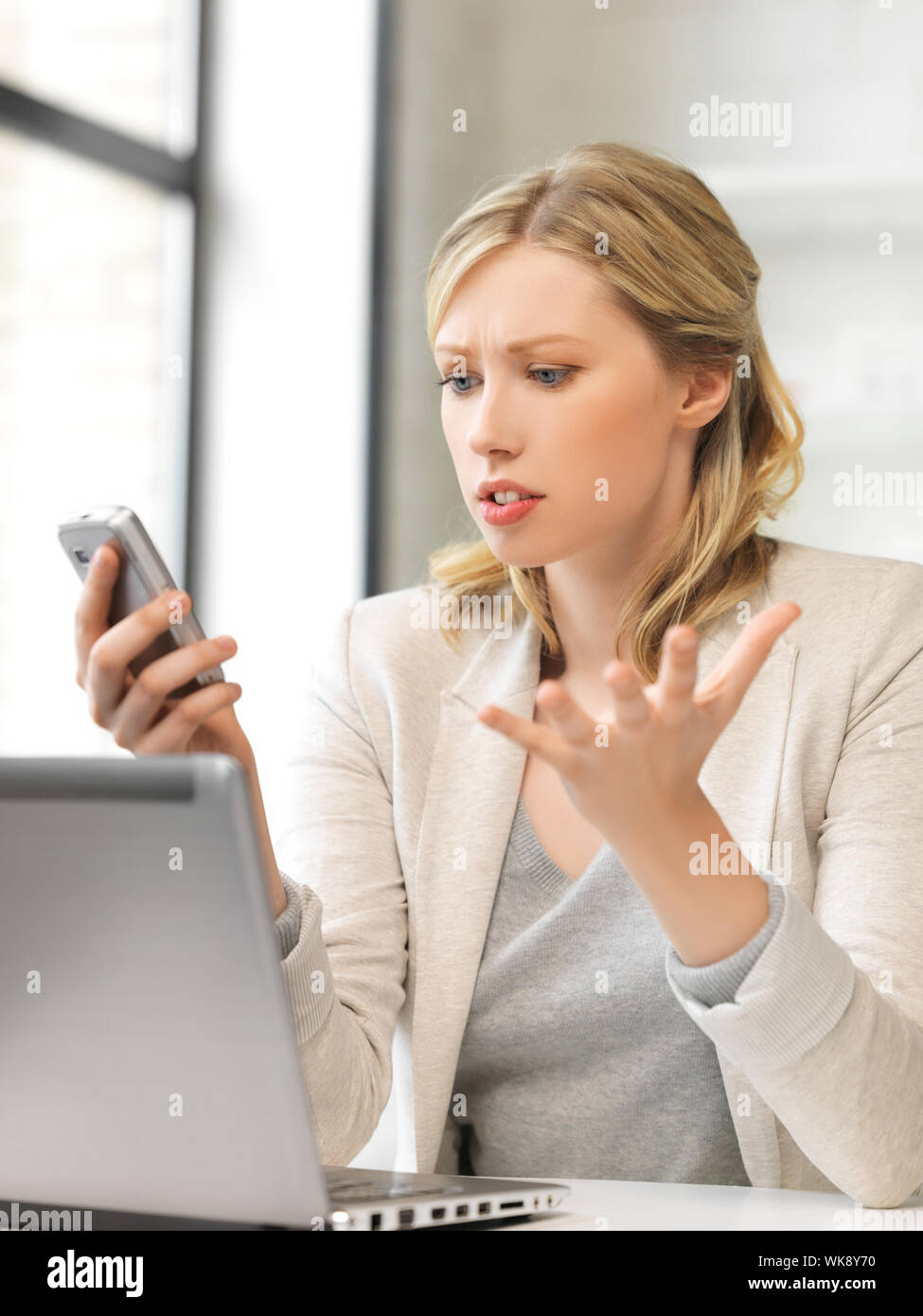 confused woman with cell phone Stock Photo - Alamy