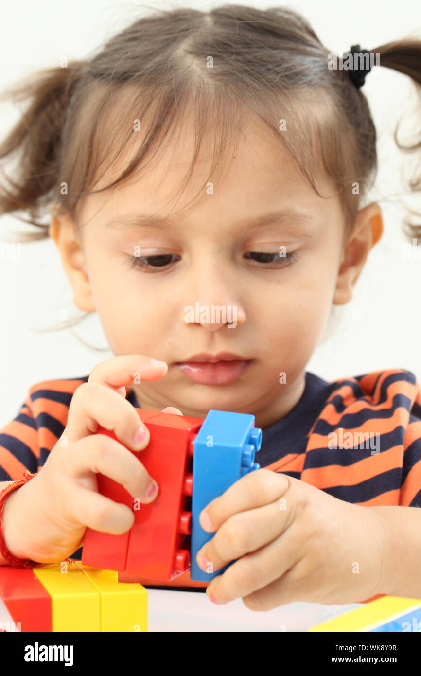 Girl playing with building blocks Stock Photo - Alamy