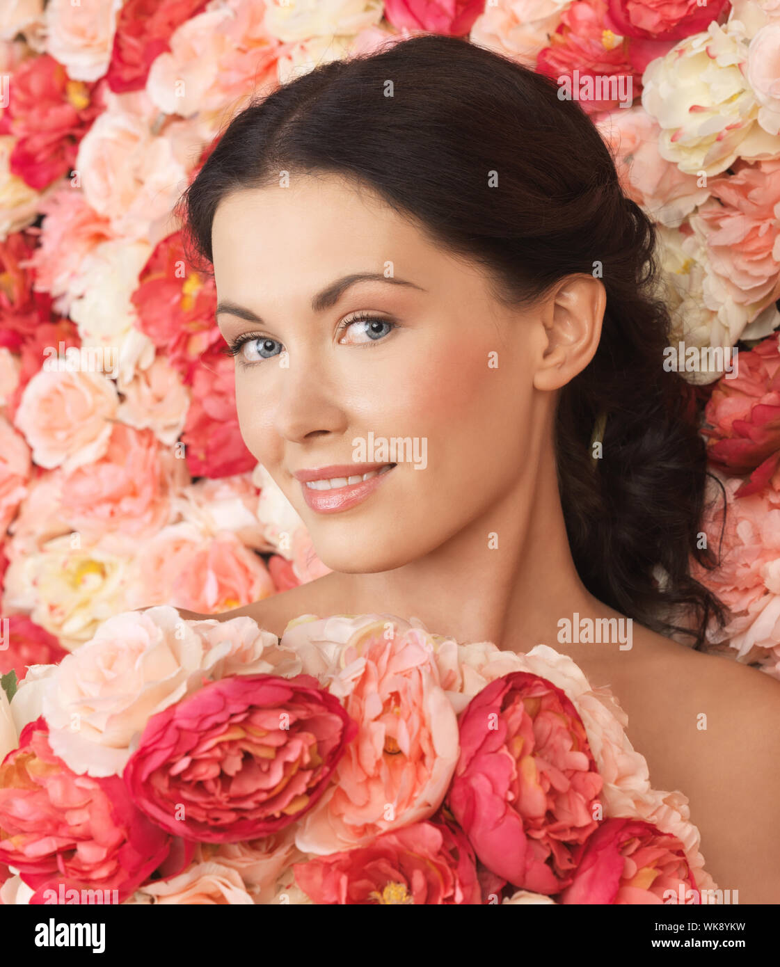 woman with background full of roses Stock Photo - Alamy