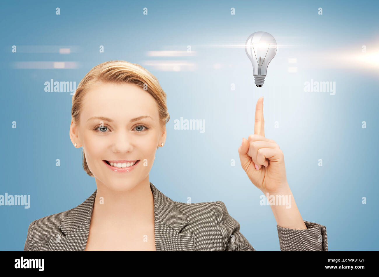 beautiful woman pointing her finger at light bulb Stock Photo - Alamy