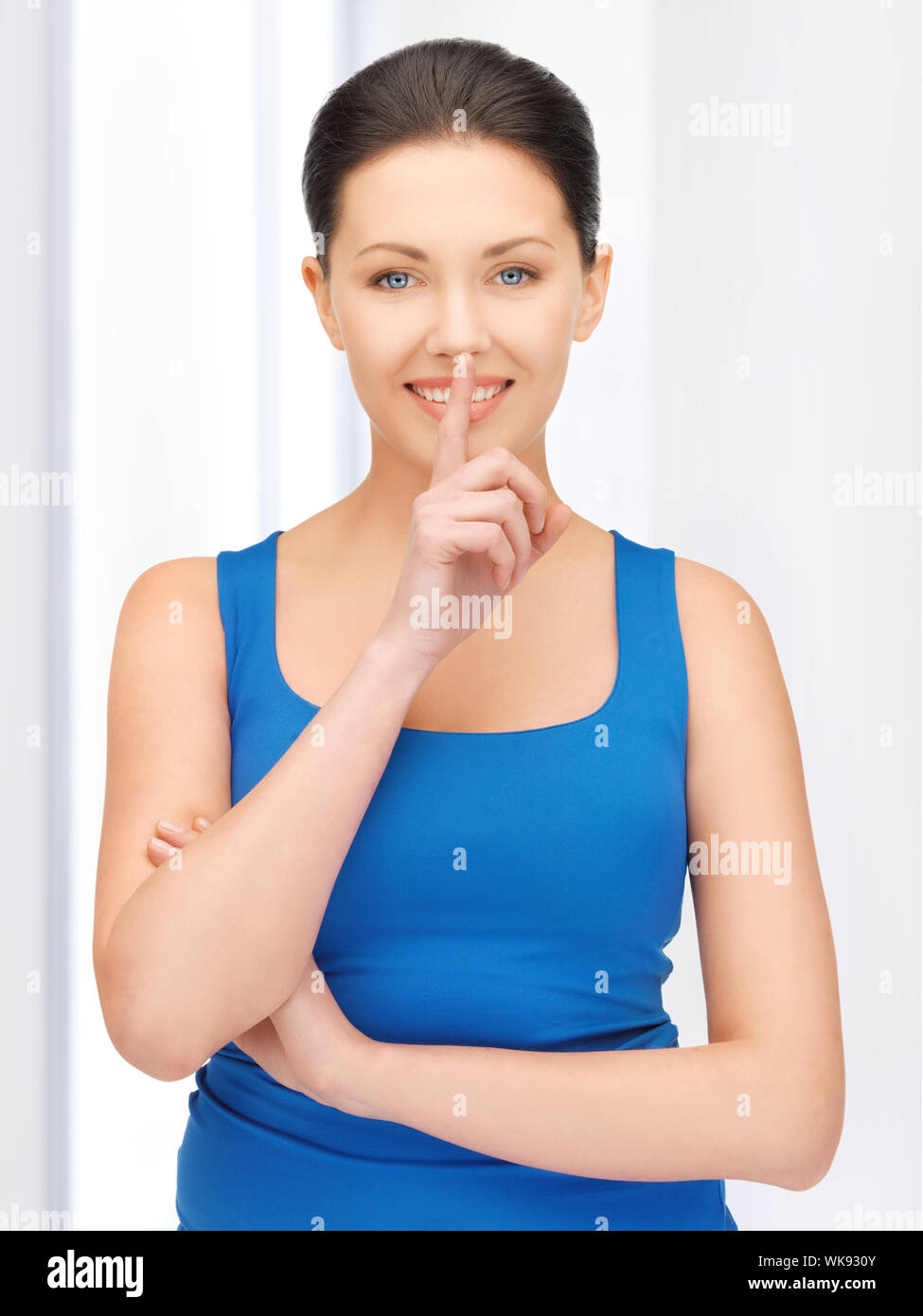 bright picture of beautiful woman making a hush gesture Stock Photo - Alamy