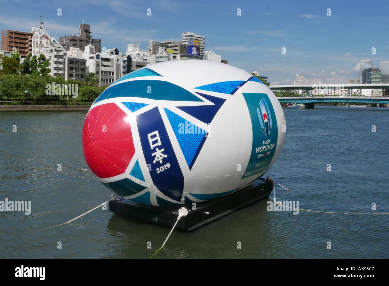 A giant rugby ball balloon floats on a river to promote the Rugby World ...