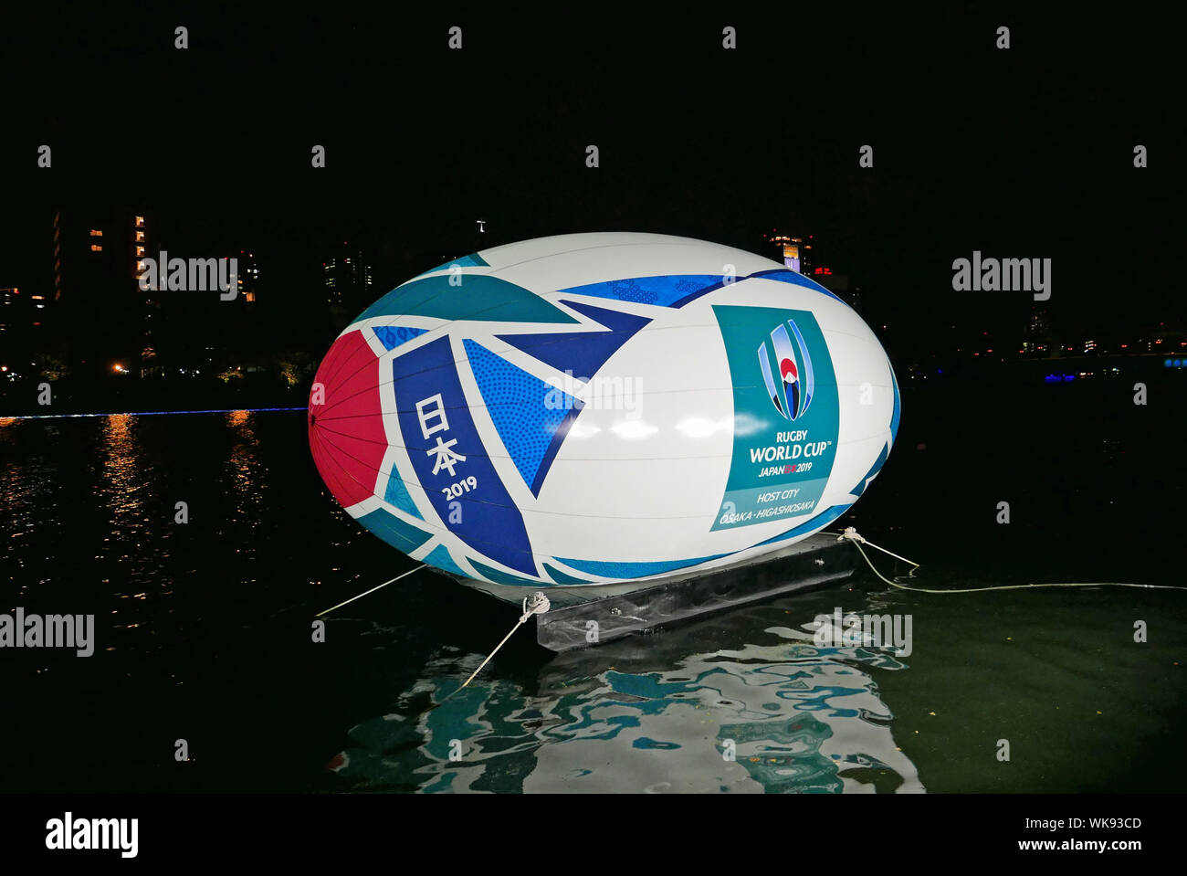 A giant rugby ball balloon floats on a river to promote the Rugby World ...