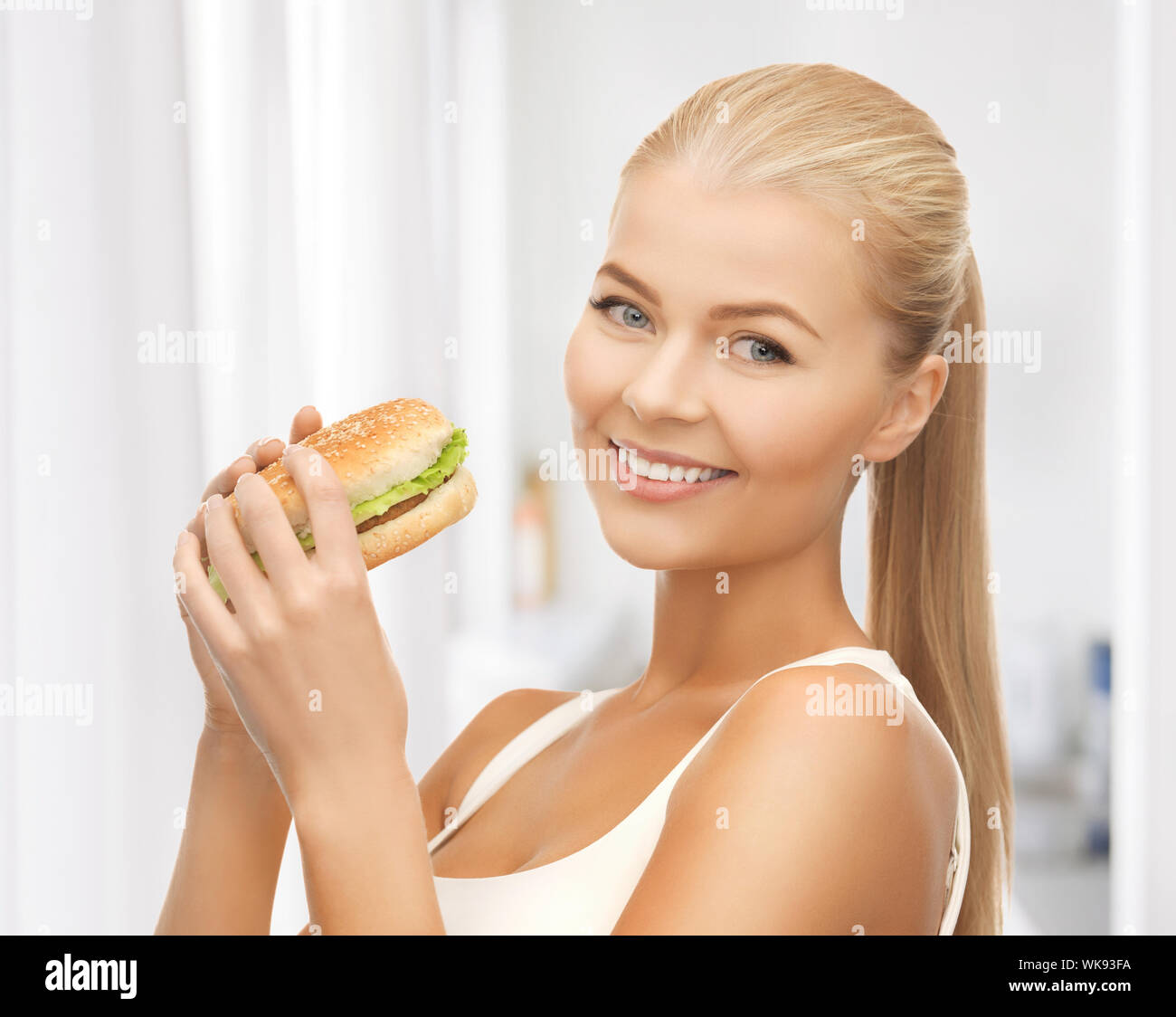 picture of healthy woman eating junk food Stock Photo - Alamy